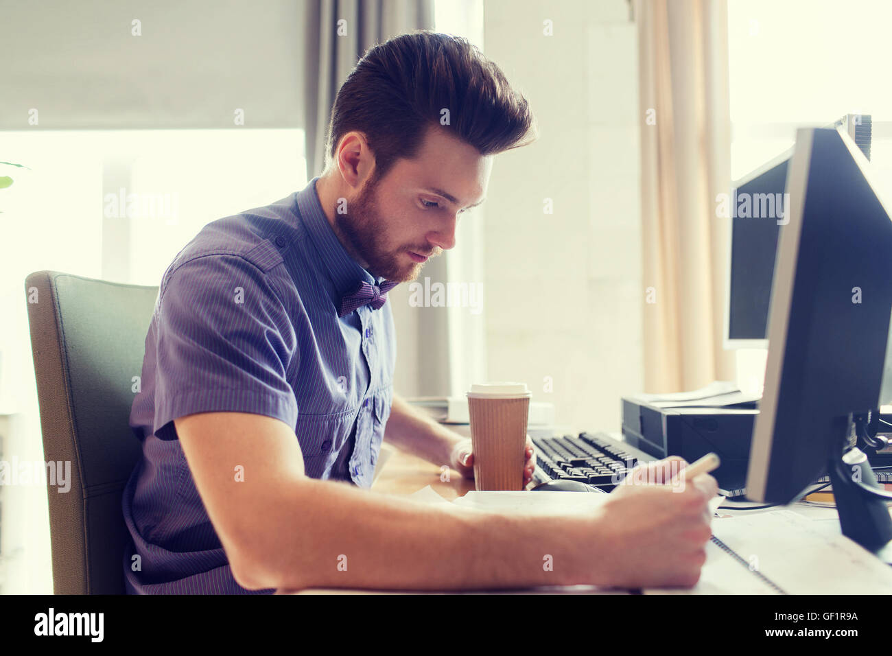 creative male office worker with coffee writing Stock Photo - Alamy
