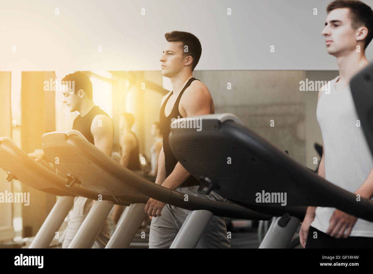 group of men exercising on treadmill in gym Stock Photo - Alamy
