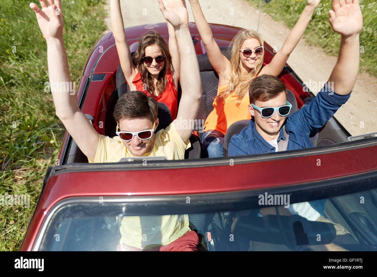 happy friends driving in cabriolet car at country Stock Photo - Alamy