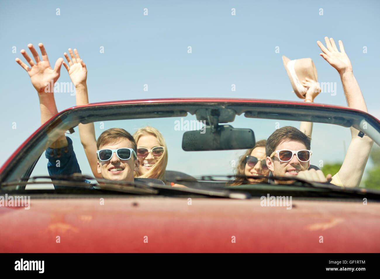 happy friends driving in cabriolet car at country Stock Photo - Alamy