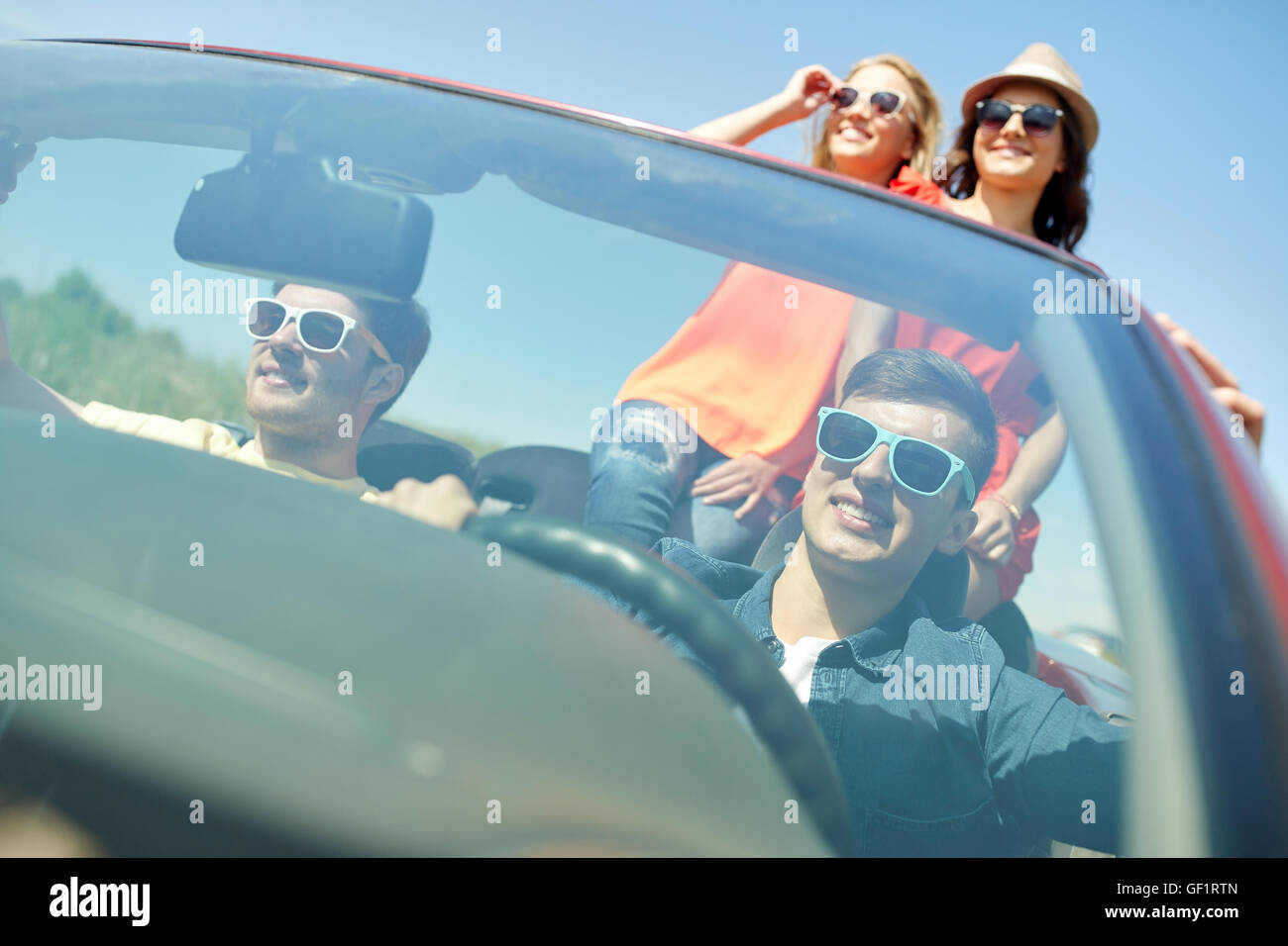 happy friends driving in cabriolet car Stock Photo - Alamy