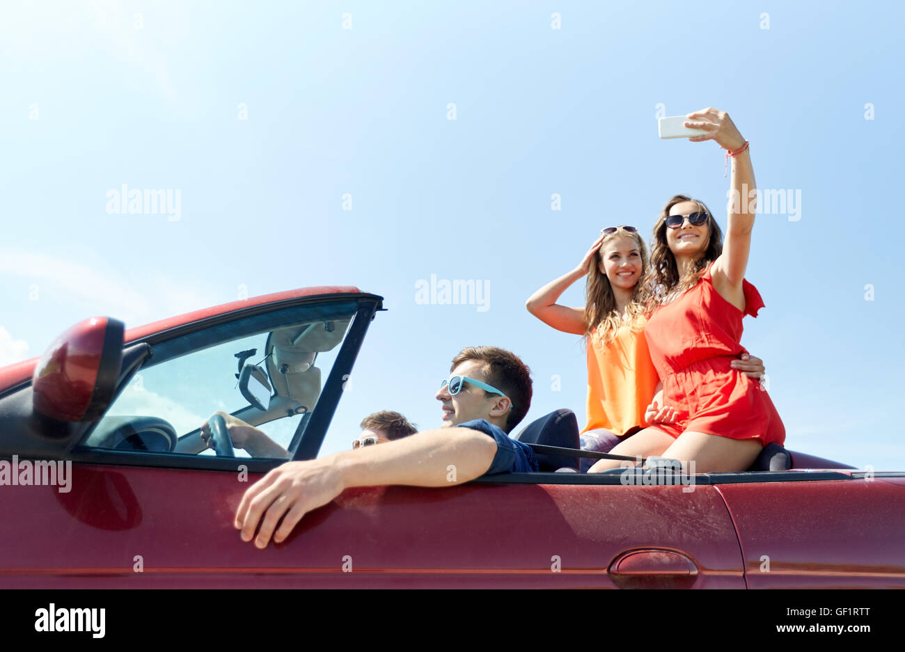friends driving in cabriolet car and taking selfie Stock Photo - Alamy