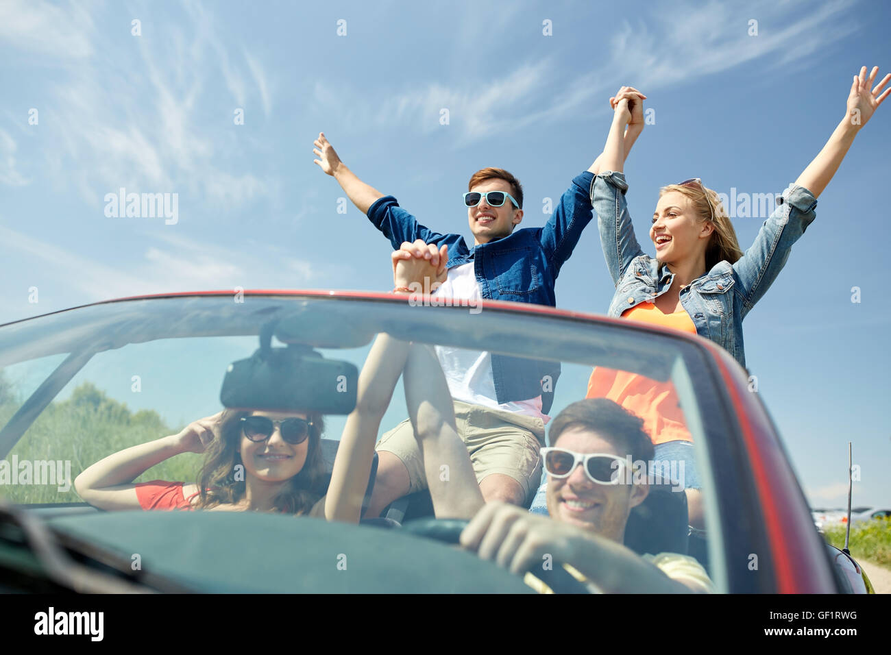 happy friends driving in cabriolet car at country Stock Photo - Alamy