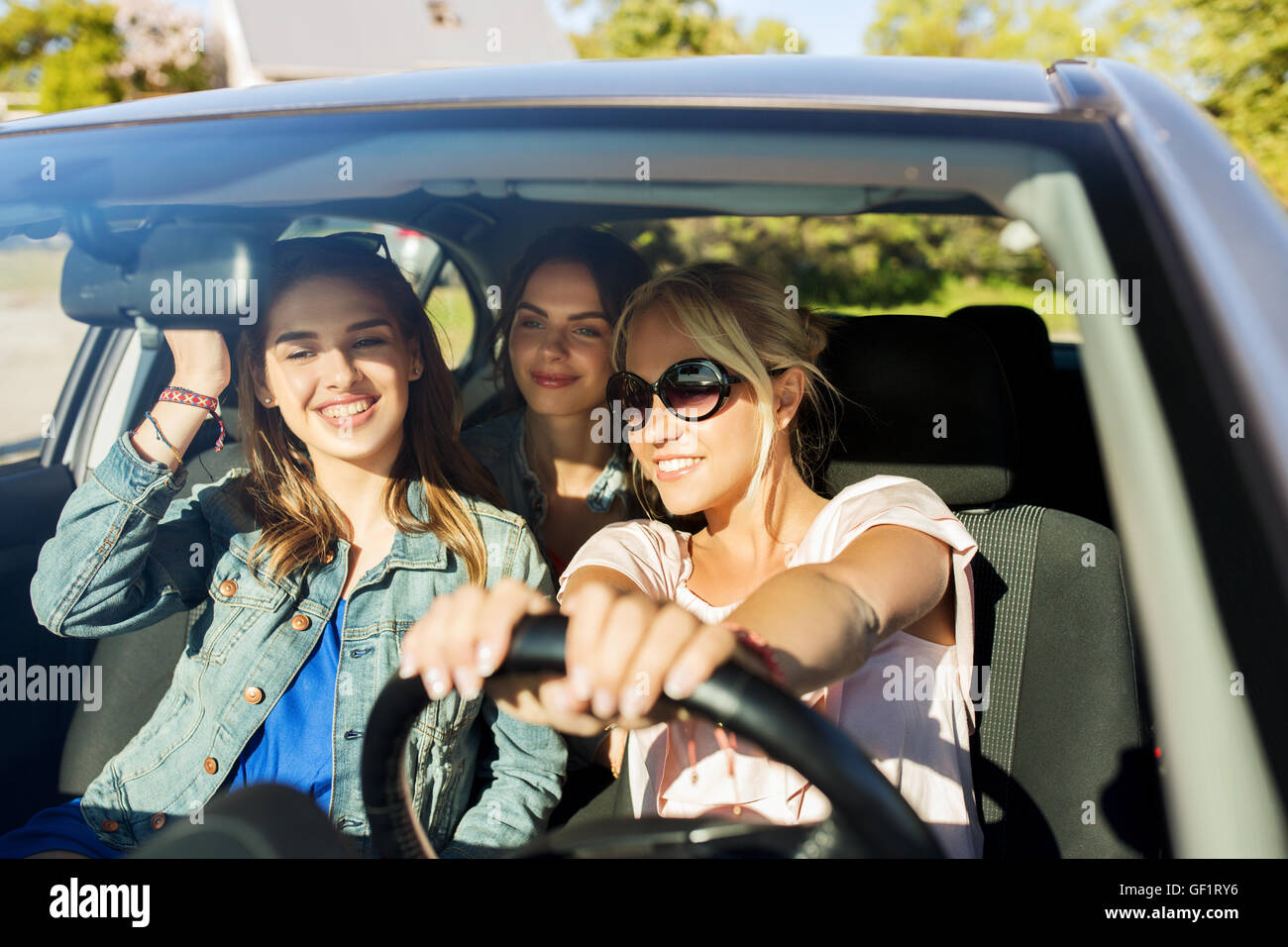 happy teenage girls or young women driving in car Stock Photo - Alamy