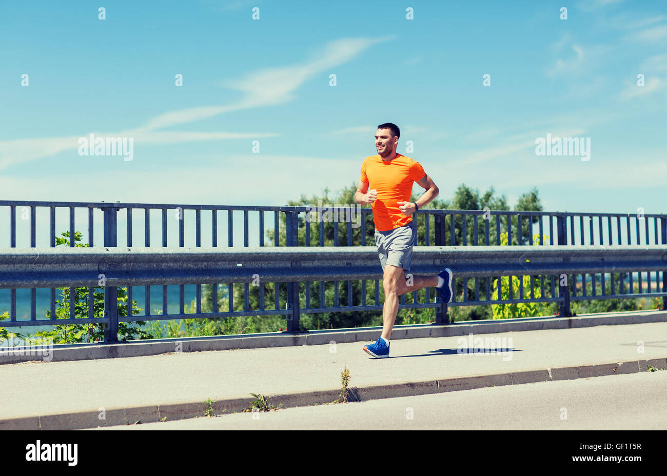 smiling young man running at summer seaside Stock Photo - Alamy