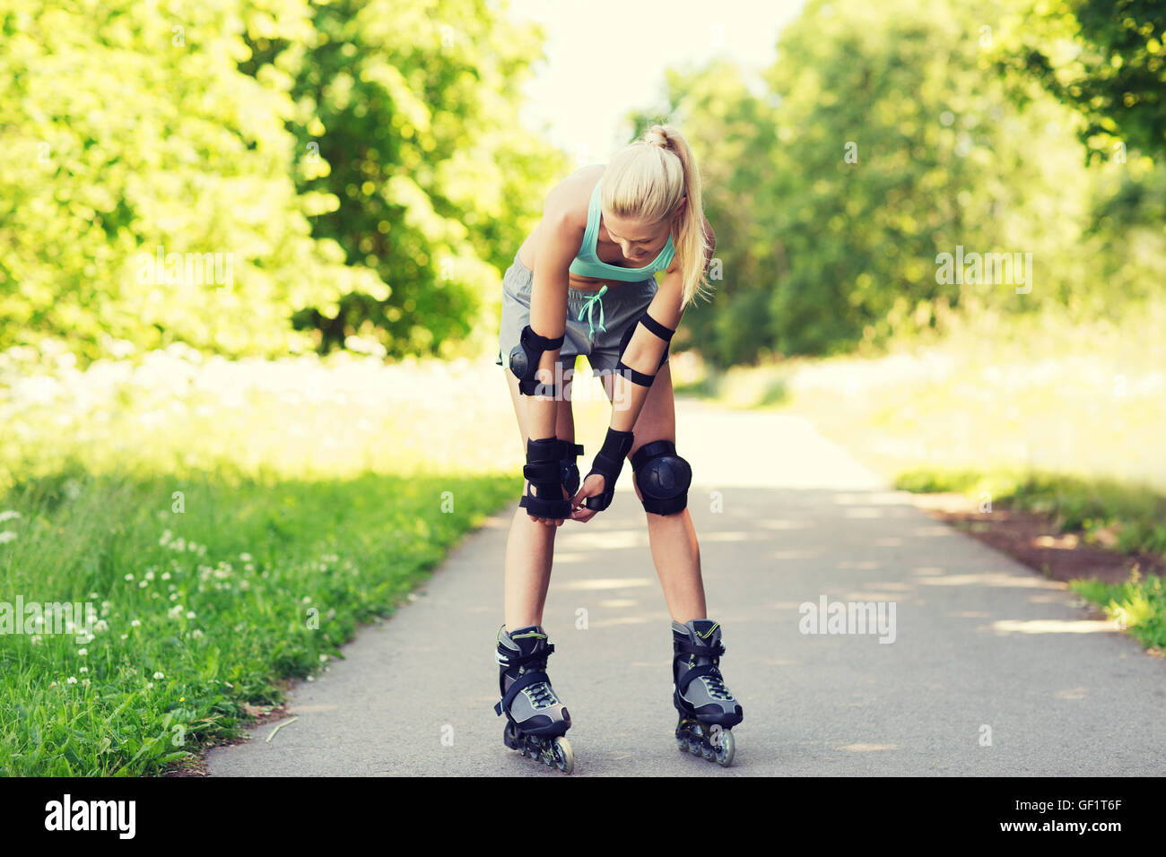 happy young woman in rollerskates riding outdoors Stock Photo - Alamy