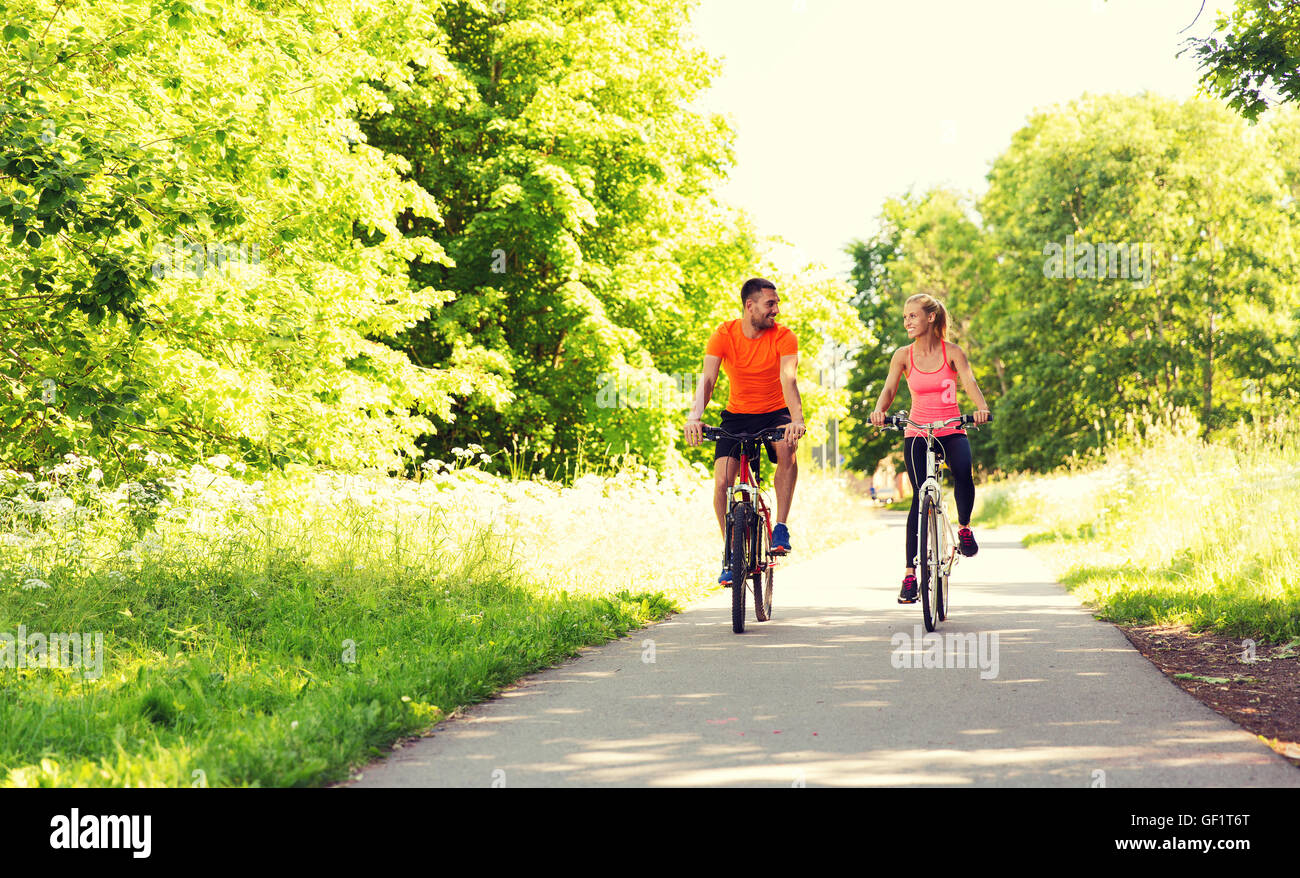 happy couple riding bicycle outdoors Stock Photo - Alamy