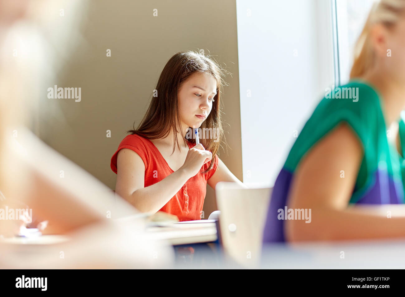 group of students with books writing school test Stock Photo - Alamy