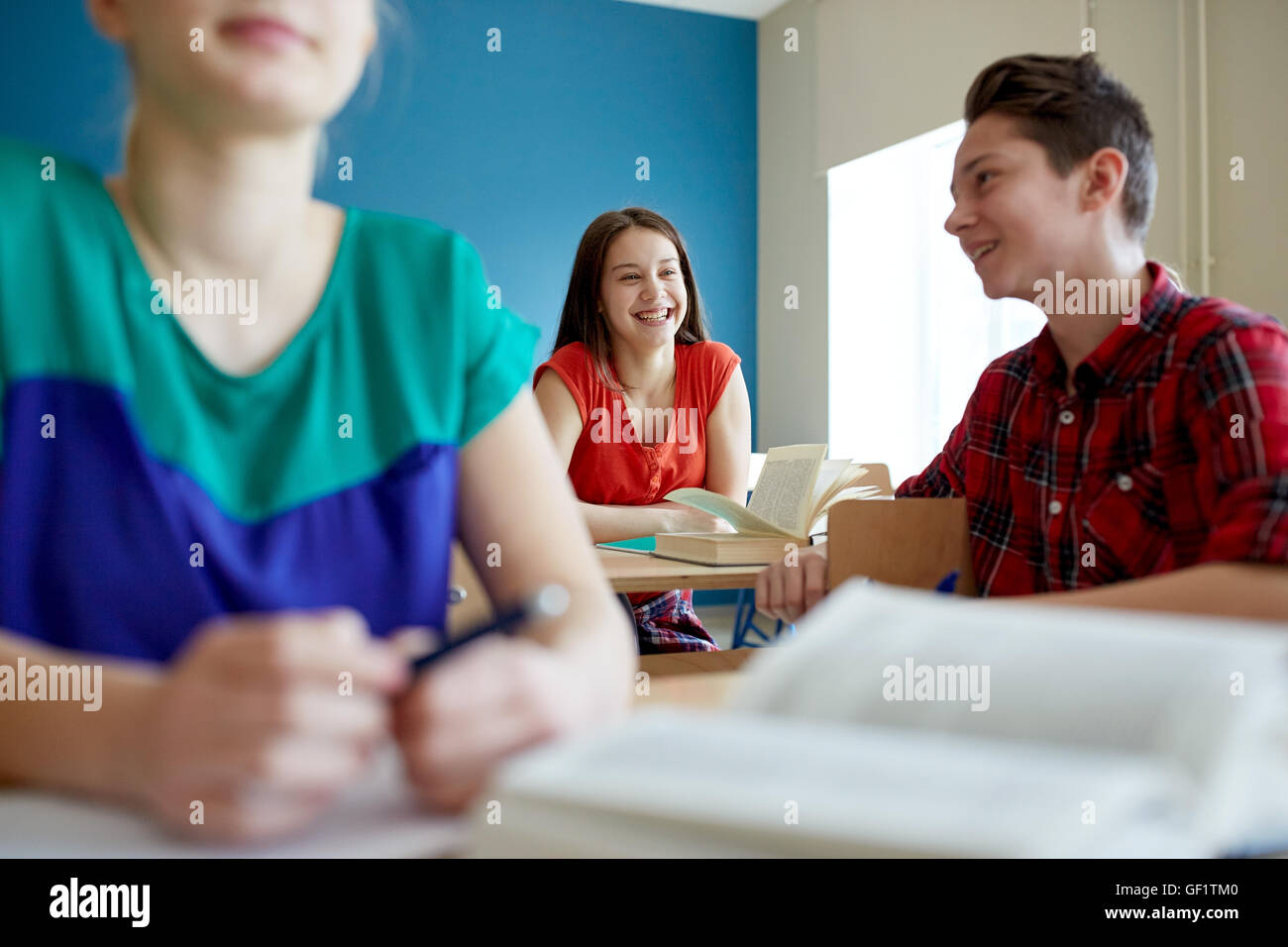 group of happy students talking at school break Stock Photo - Alamy