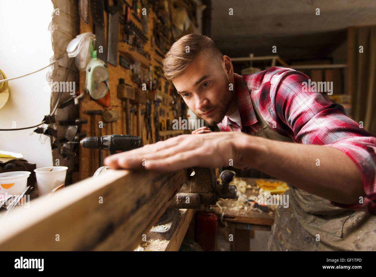 carpenter working with wood plank at workshop Stock Photo - Alamy