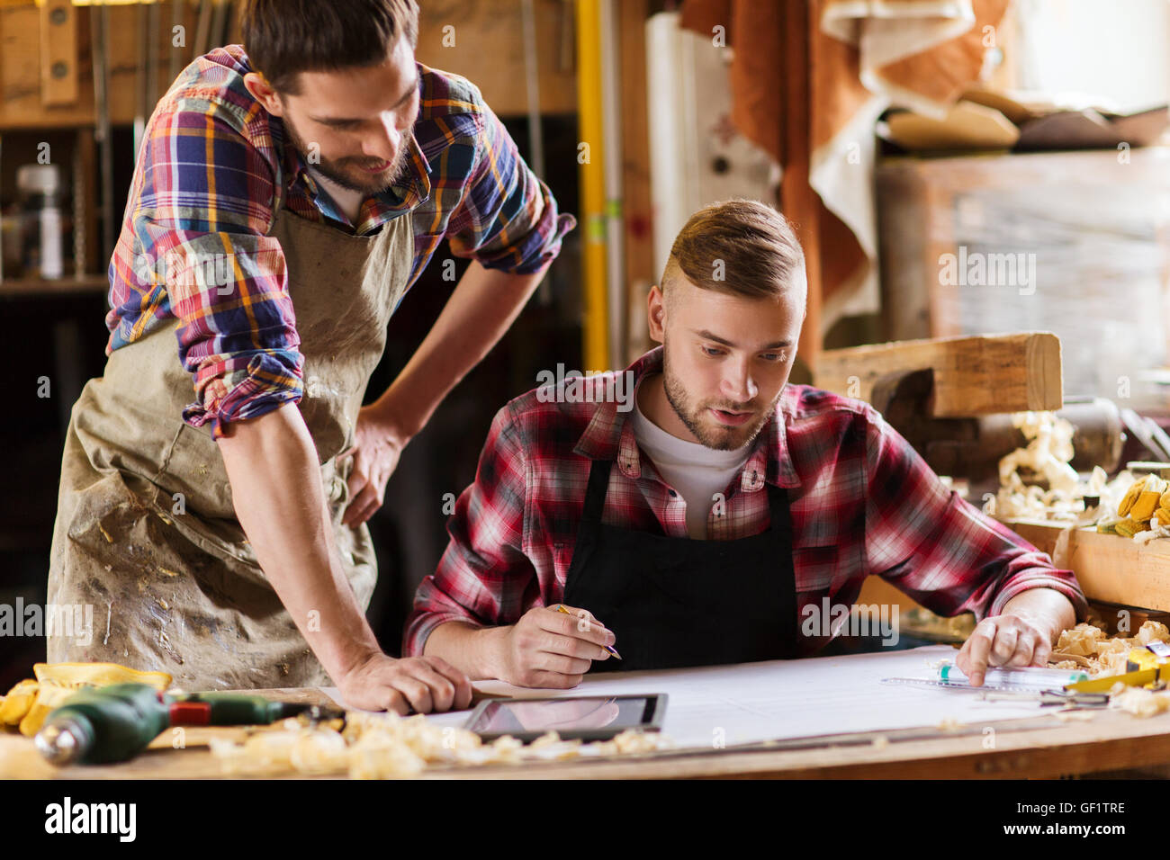 carpenters with ruler and blueprint at workshop Stock Photo - Alamy