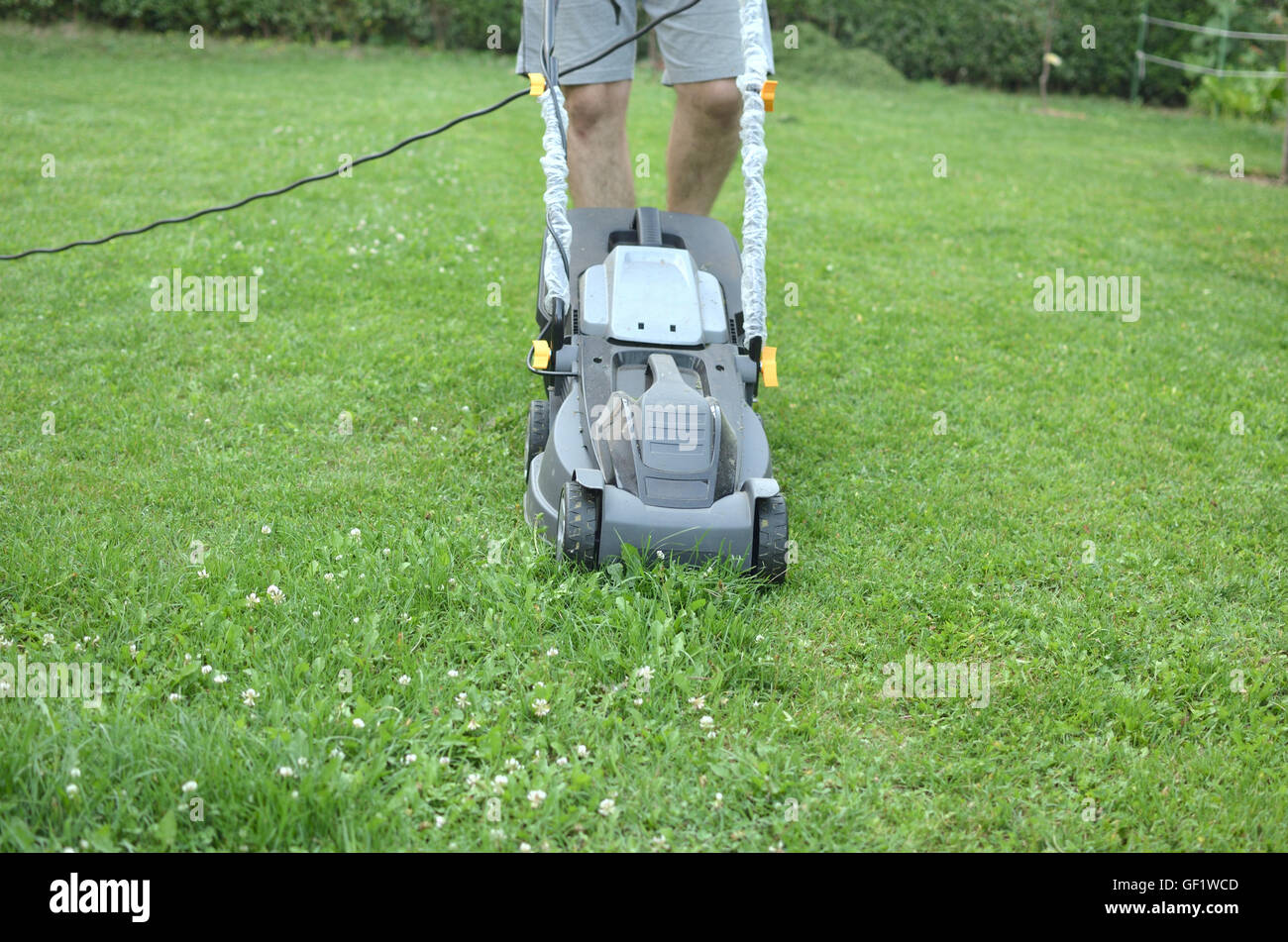 Person pushing a lawn mower hi-res stock photography and images - Alamy