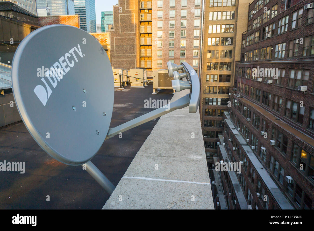 A DirecTV satellite dish on the rooftop of a building in New York on ...