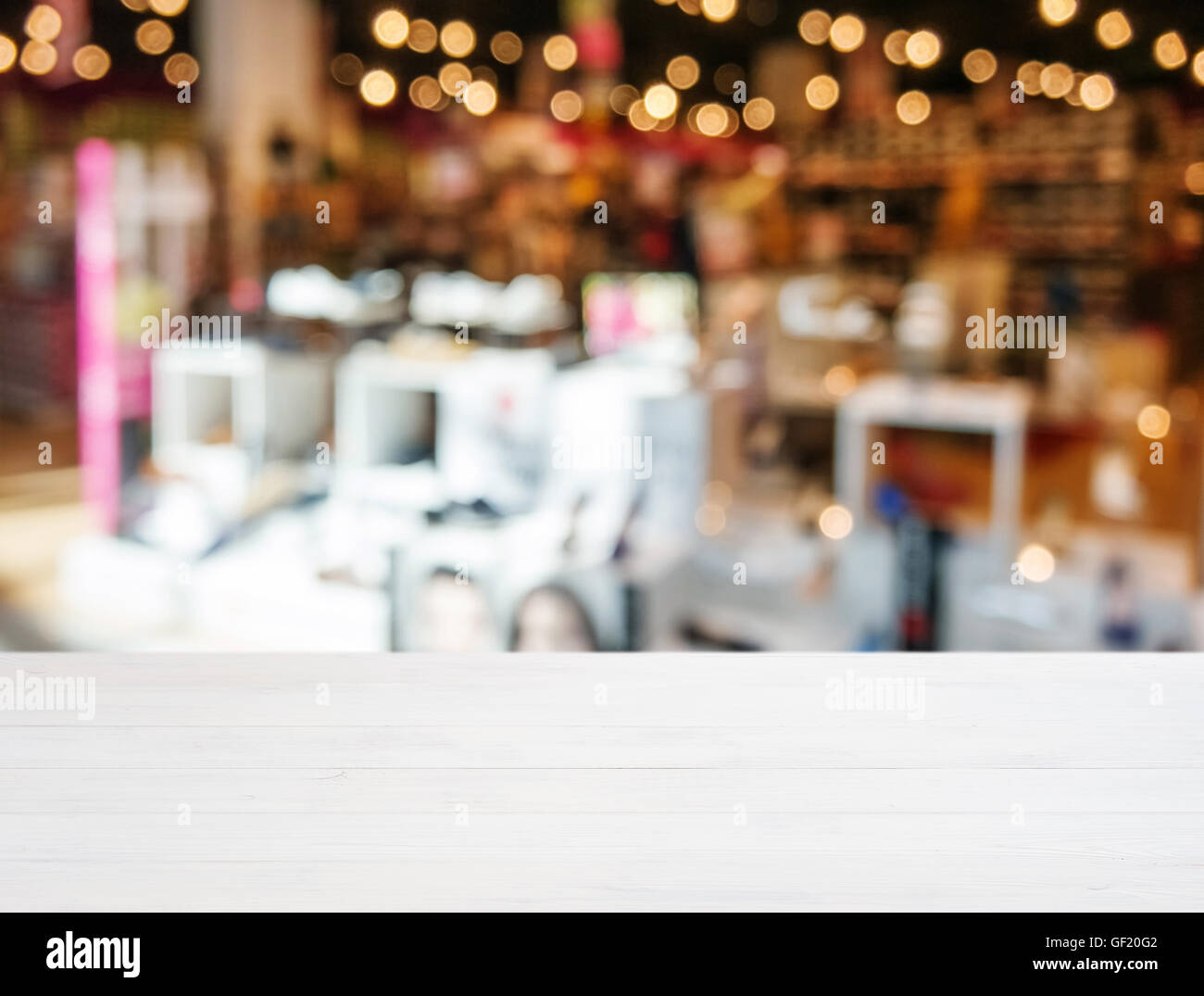 Wooden empty table and blurred background store Stock Photo - Alamy