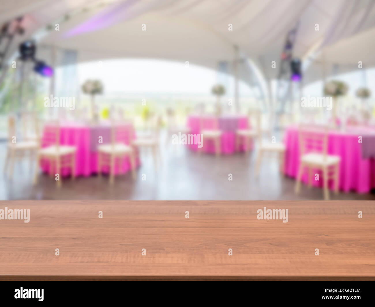 Wooden empty table in front of blurred restaurant Stock Photo - Alamy