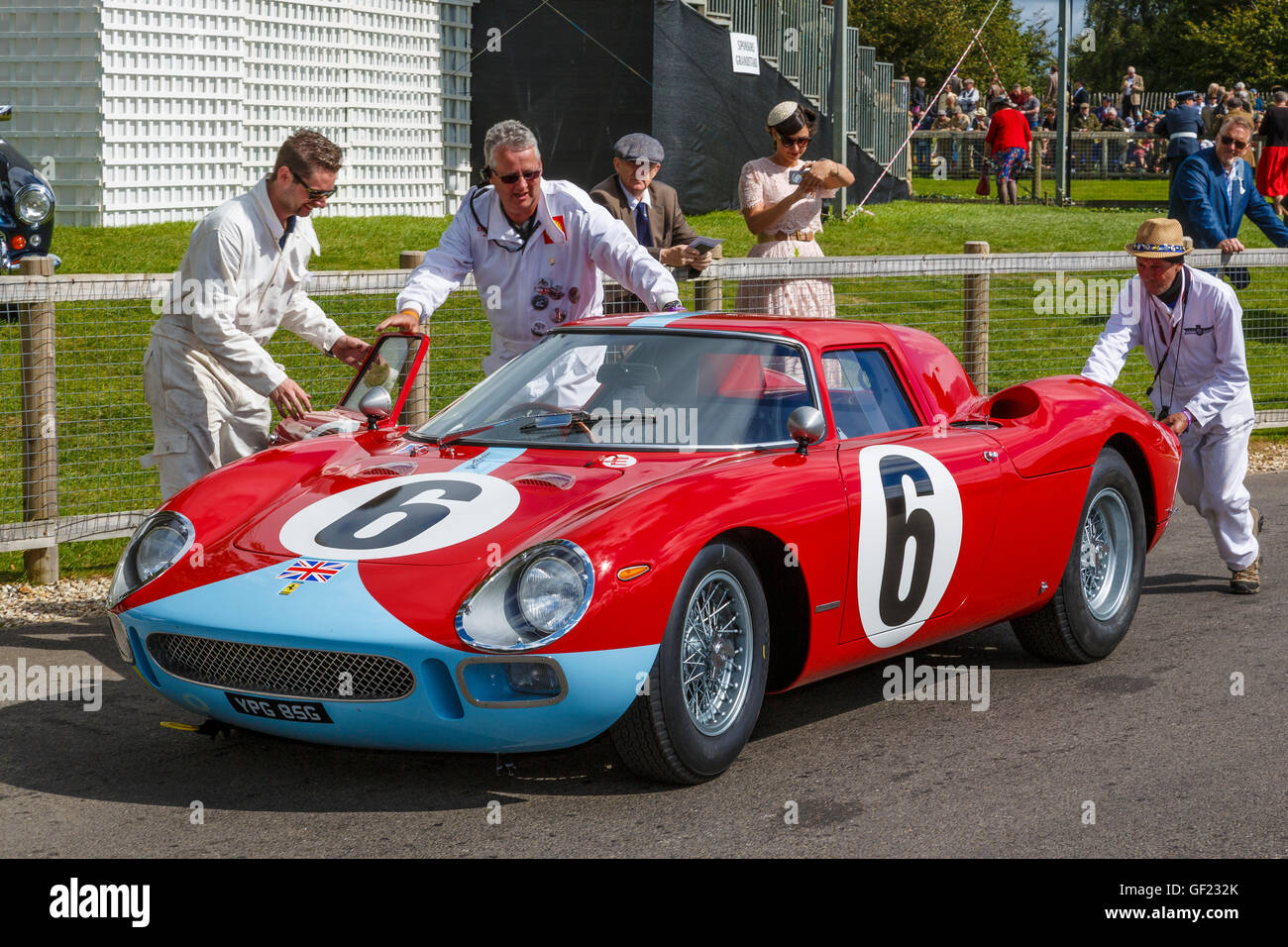 Mechanics pushing the 1964 Ferrari 250 LM trough the paddock. RAC TT ...