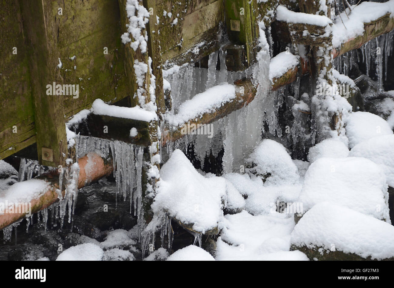 Fish ladder at a damming in frost. The streaming undercooled water has ...