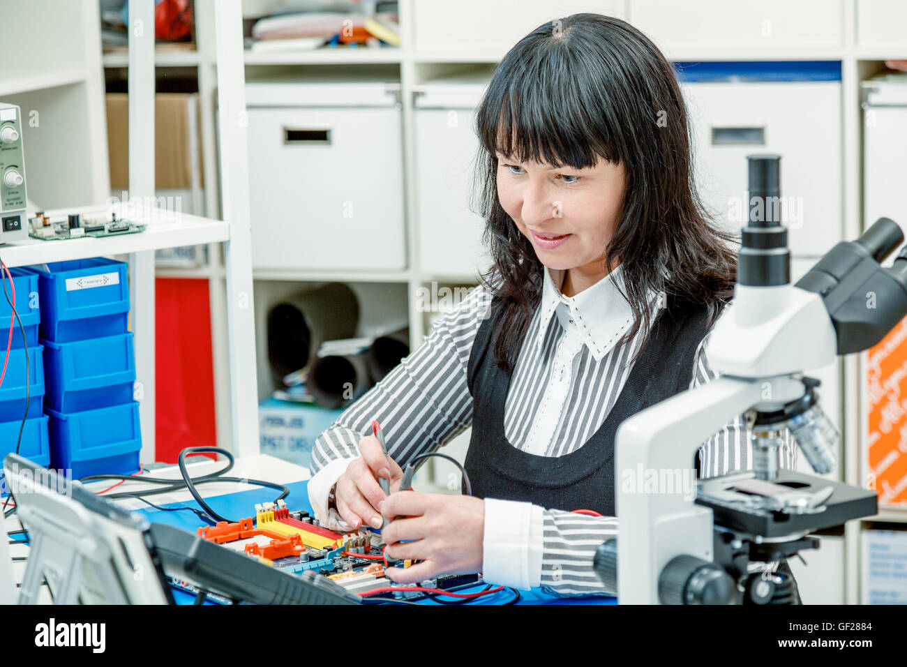 Woman in electronics laboratory Stock Photo - Alamy