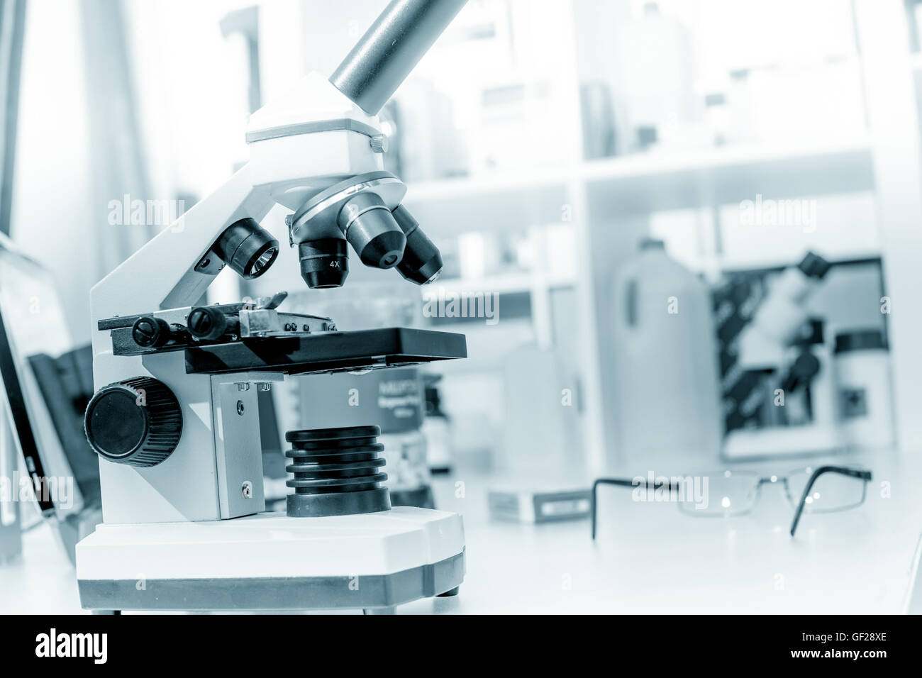 monocular microscope on blue background Stock Photo - Alamy