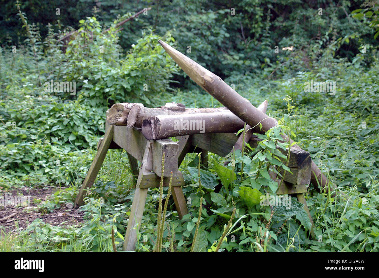 Saw horse with tree trunks and a mighty sharpened fence post pointing ...