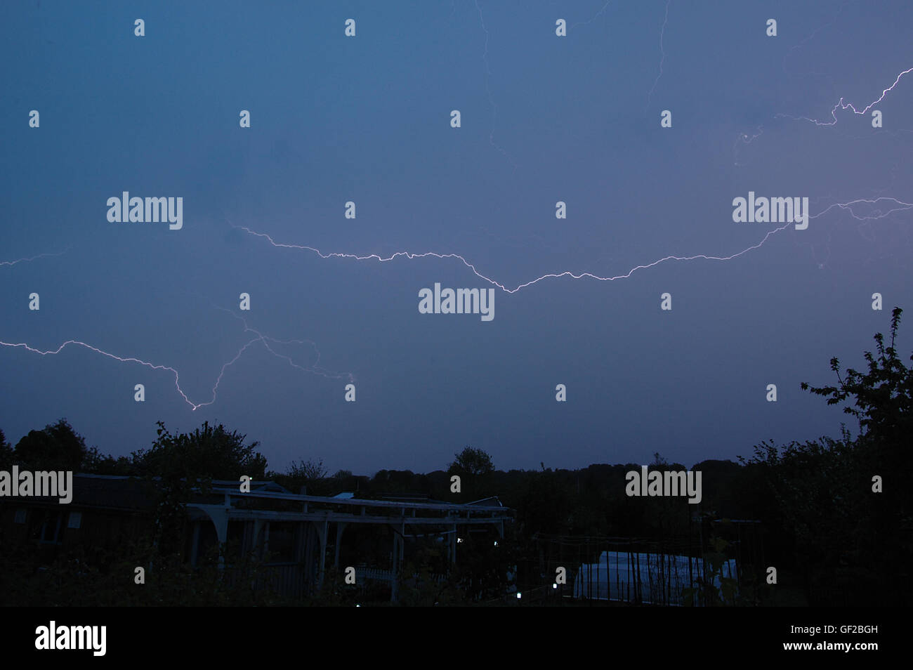 Lightening at night, lightening bolts form their paths on a dark sky ...