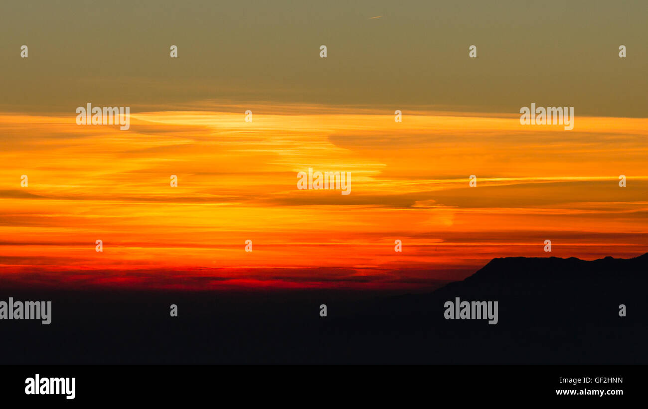 Mountain silhouette on red sunset from Italian Alps. Clouds background ...