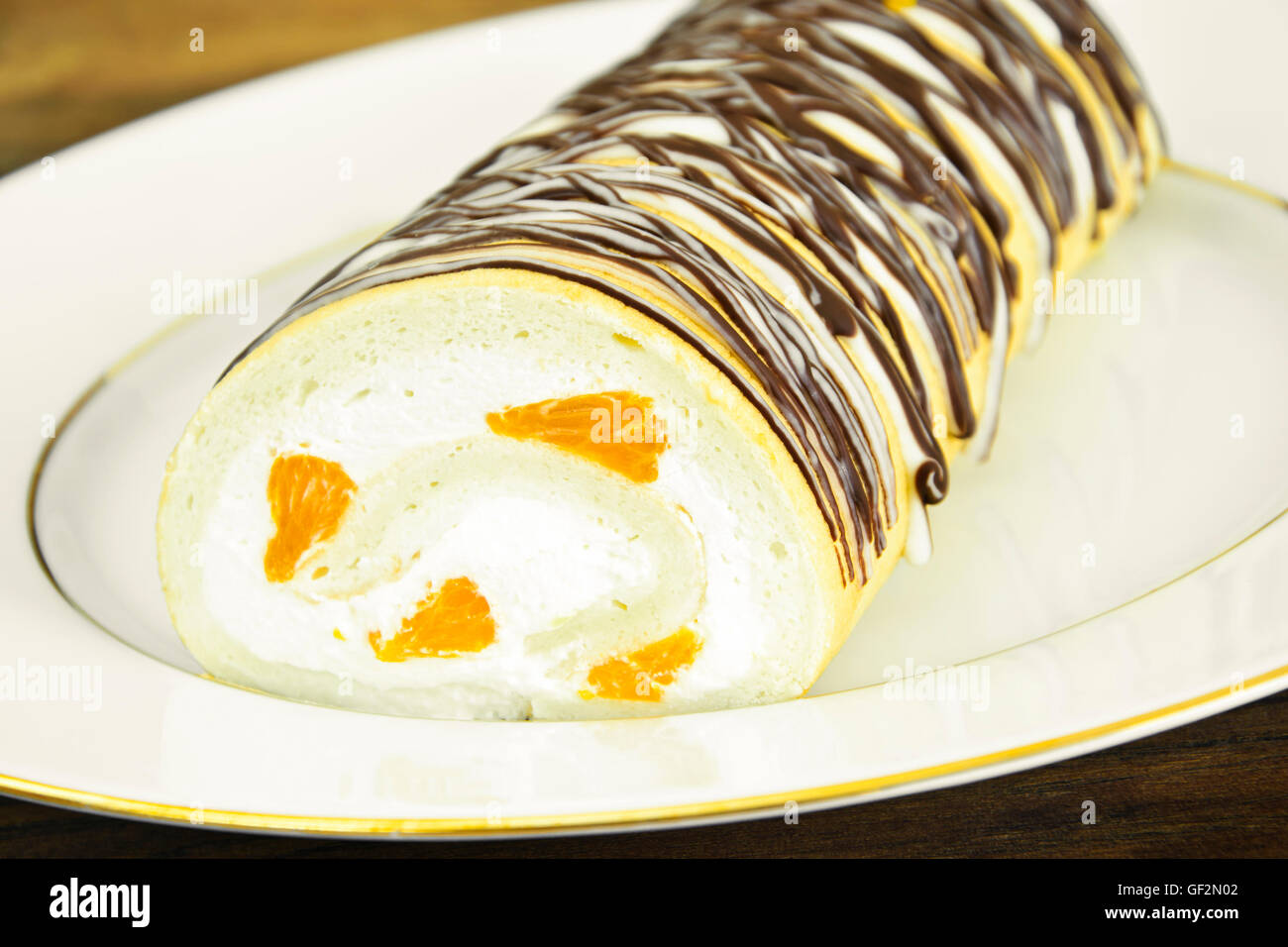 Sponge Roulade with Cream, Mandarin and Cherry Stock Photo - Alamy