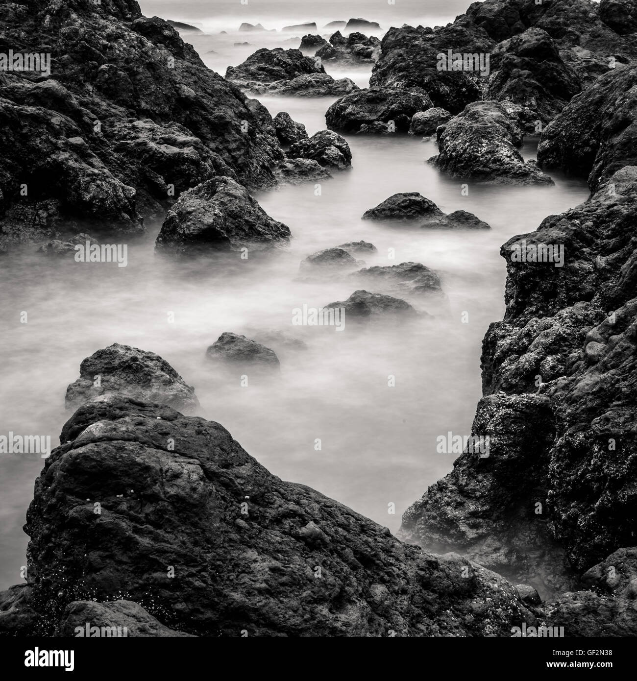 motion blur water surrounding rocks, black and white Stock Photo - Alamy
