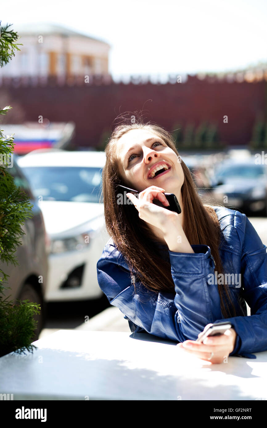 Young happy woman calling by phone on the street Stock Photo - Alamy