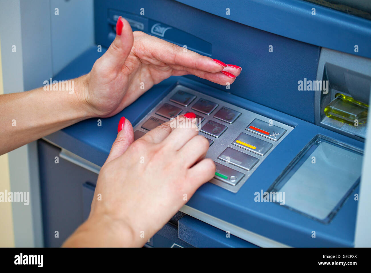 Female arms, ATM - entering pin Stock Photo - Alamy