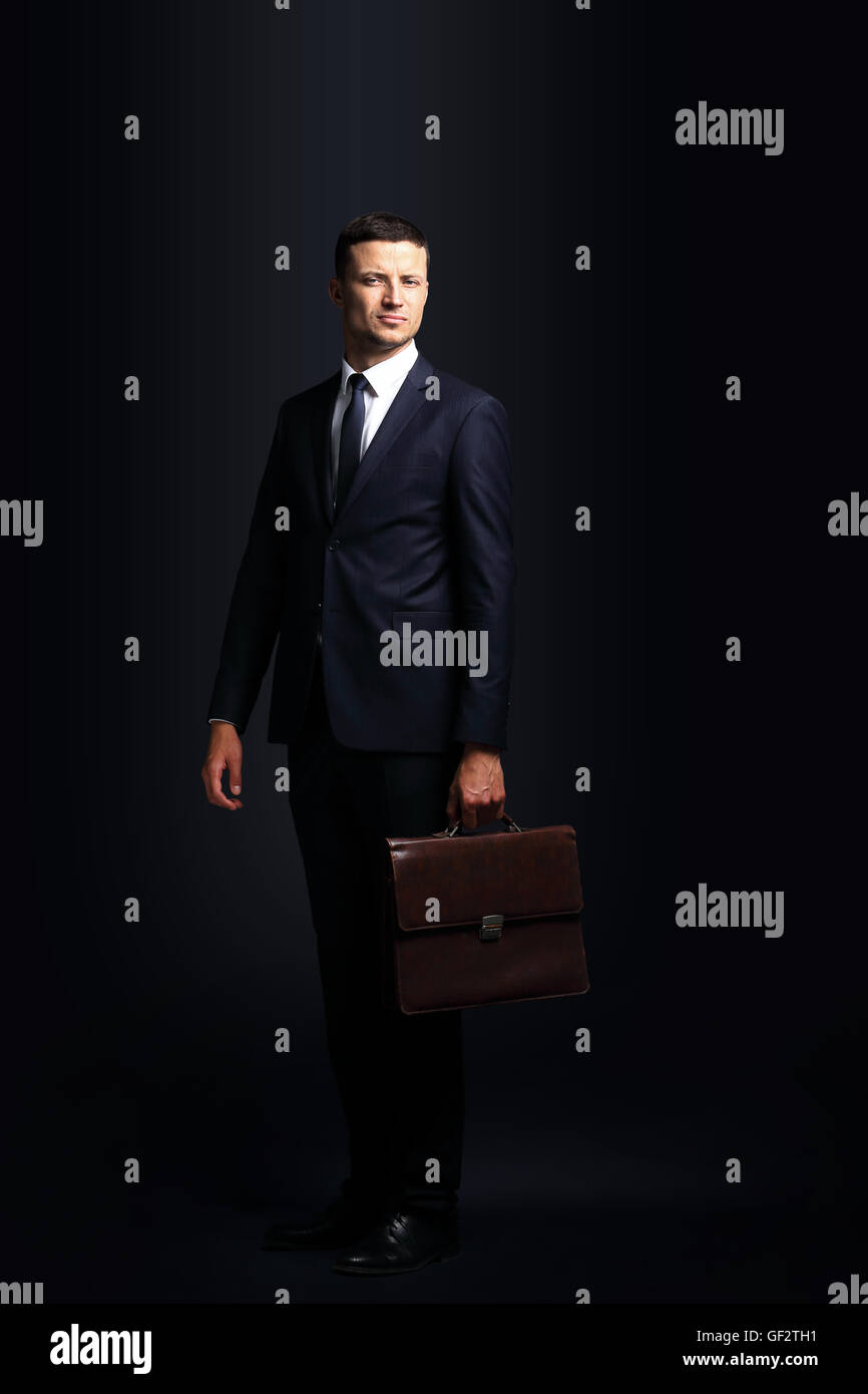 Portrait of a handsome business man with briefcase isolated on Stock ...