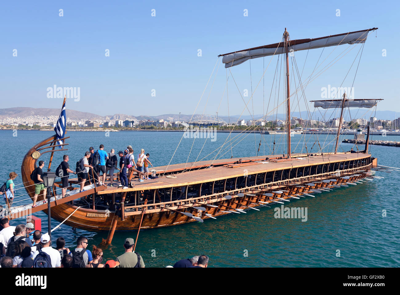 Volunteer rowers getting on board a full scale copy of an ancient ...