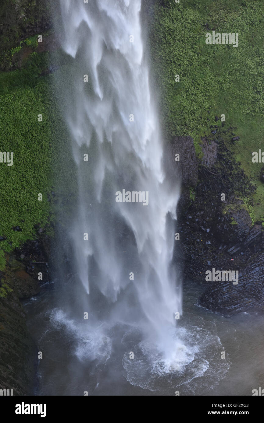 Waterfall pouring water into small lake Stock Photo - Alamy