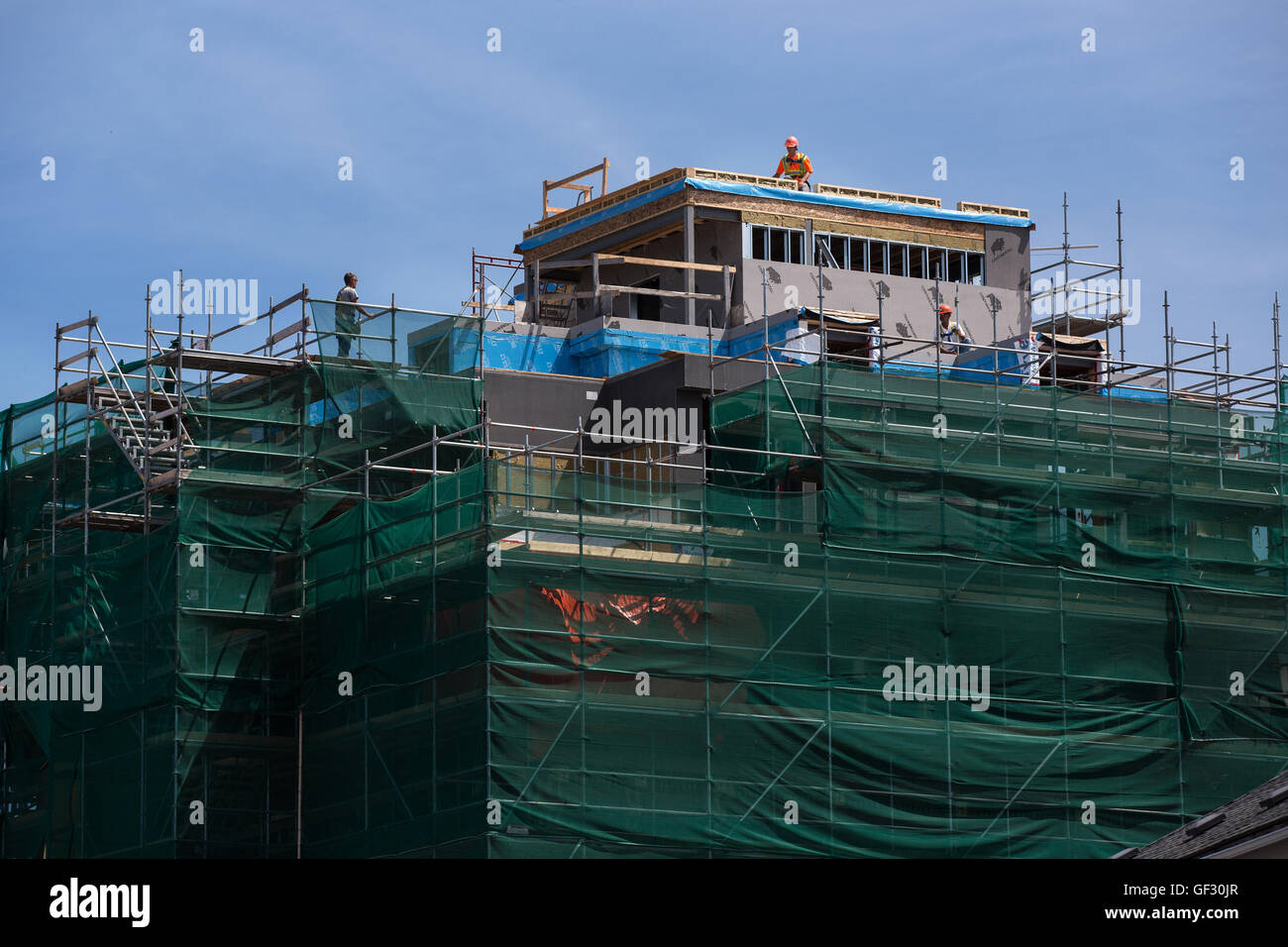 Construction crew work on a apartment building in downtown Kingston ...