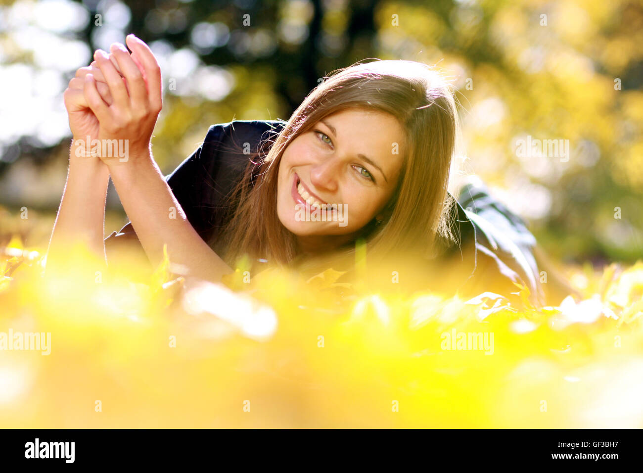 Beautiful young woman in autumn park Stock Photo - Alamy