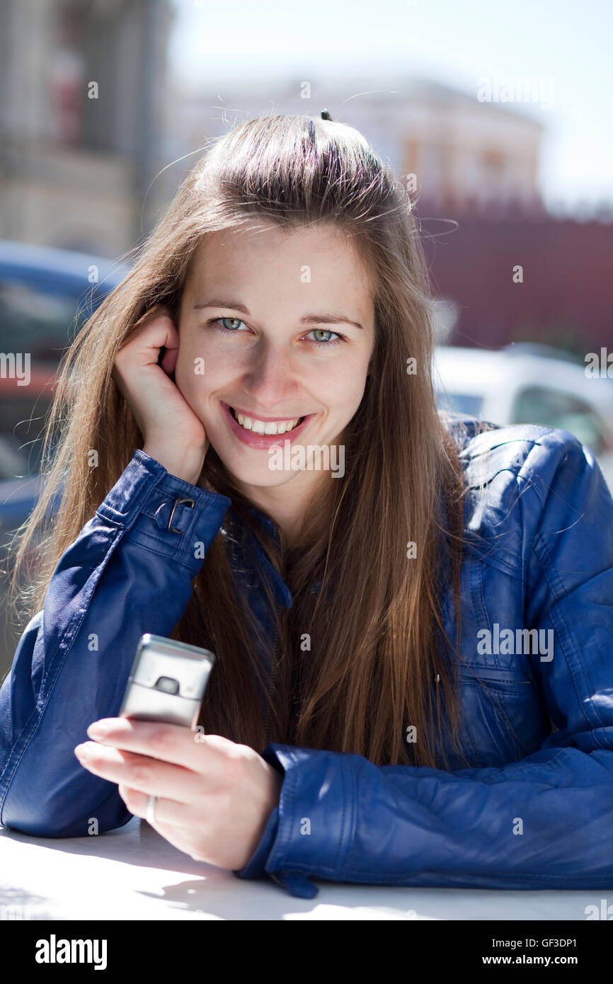 Young woman reading a message on the phone Stock Photo - Alamy