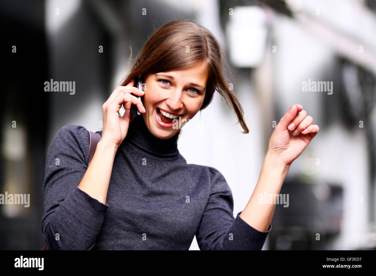 Young happy woman calling by phone on the street Stock Photo - Alamy