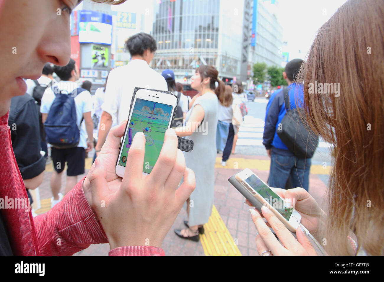 People play the mobile game "Pokemon Go" on their smartphones in ...