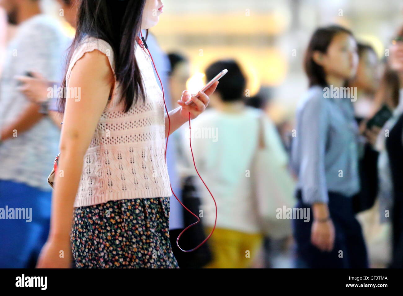 People look at their smartphones in Tokyo, Japan on July 27, 2016 ...