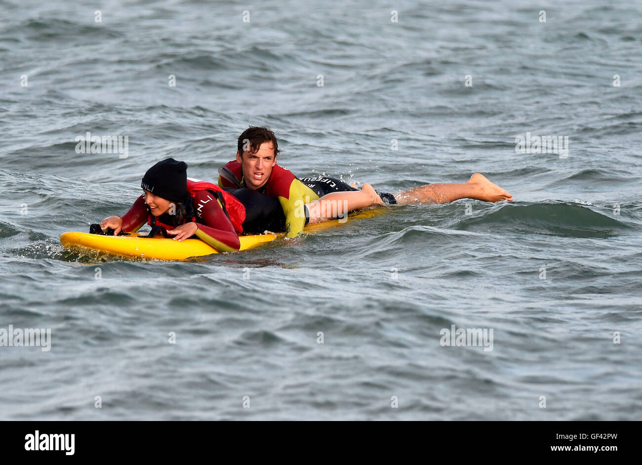 RNLI Surf Lifeguard rescues a swimmer, Coastguard Rescue, Coastguards ...