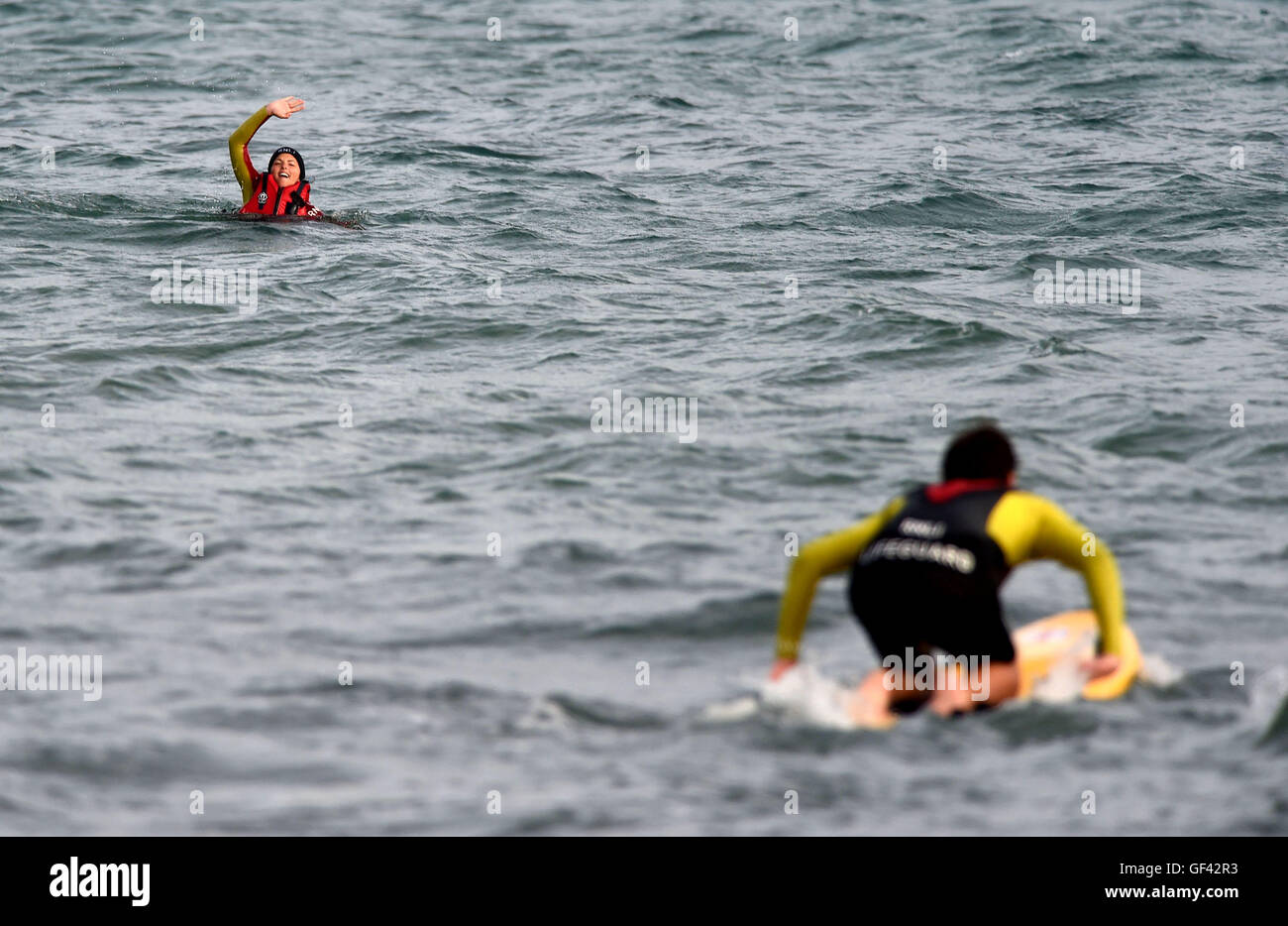 Lifeguard Rescue member goes to the rescue of a swimmer, RNLI "Lifeboat ...