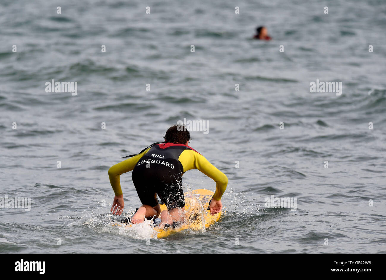Lifeguard Rescue member goes to the rescue of a swimmer, RNLI "Lifeboat ...