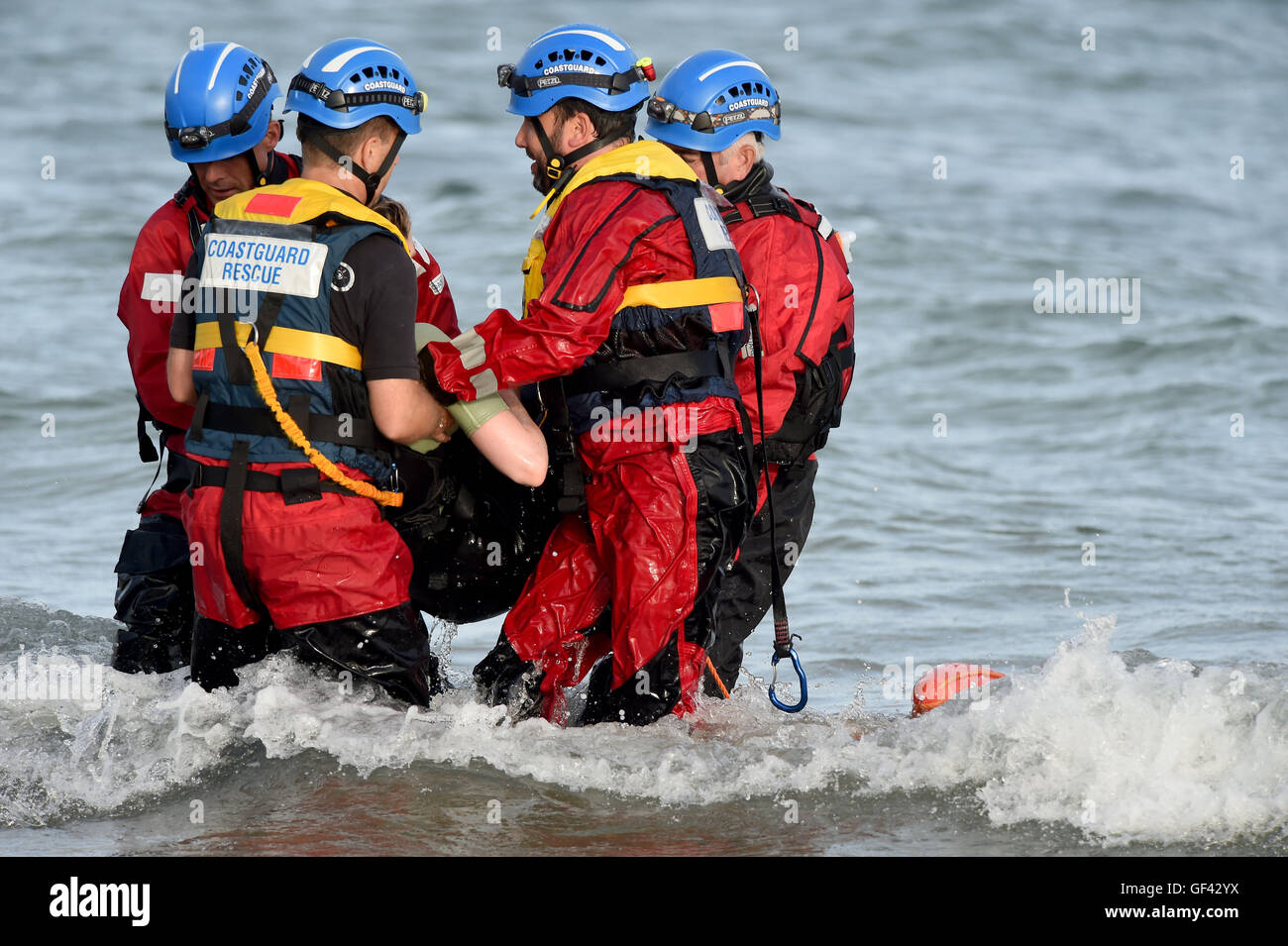 Coastguard Rescue carry a person from the sea, Coastguards Rescue, RNLI ...