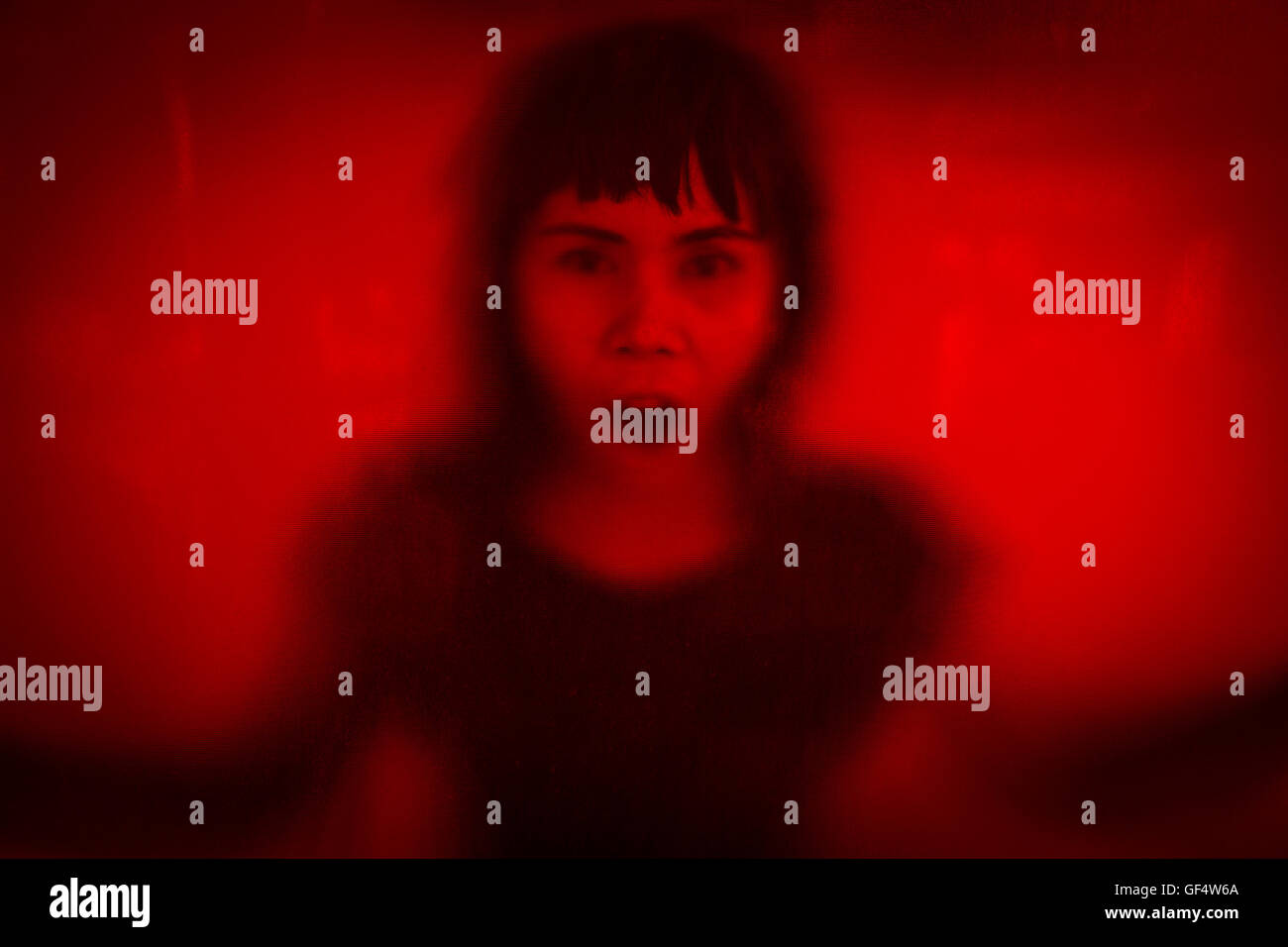 Woman screaming behind stained or dirty window glass,Scary background ...