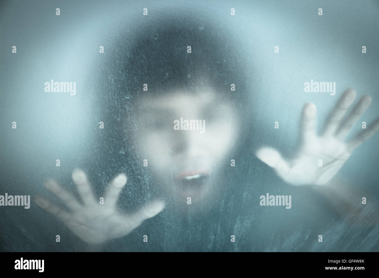Woman screaming behind stained or dirty window glass,Scary background ...