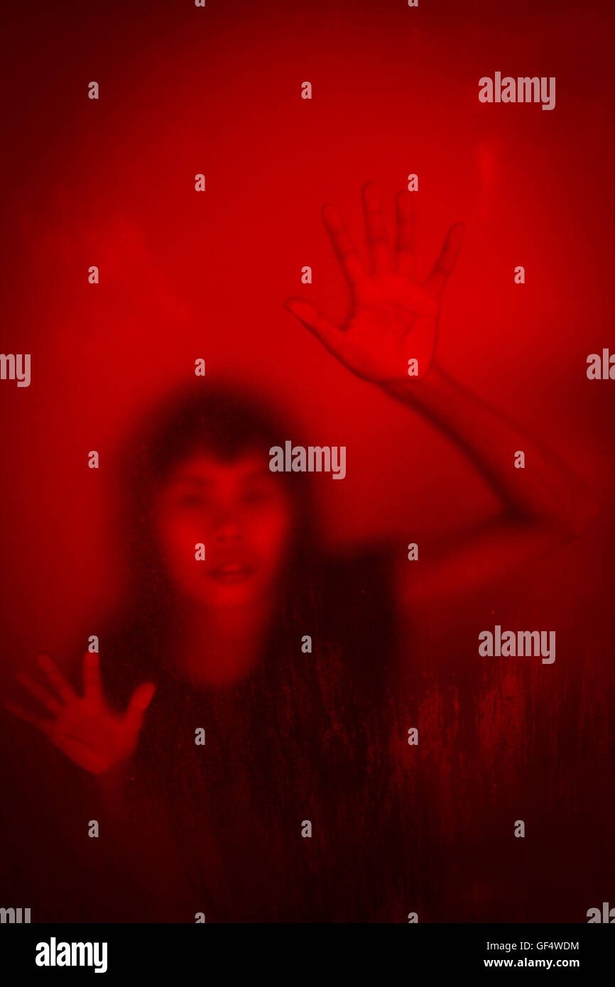Woman screaming behind stained or dirty window glass,Scary background ...