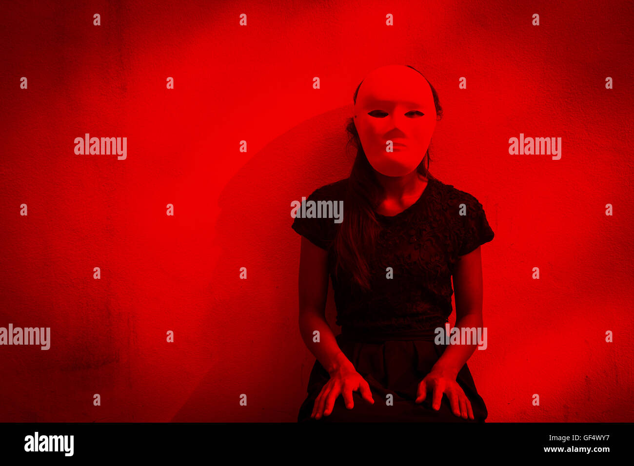 Mysterious woman in black dress wearing white mask,Scary background for ...