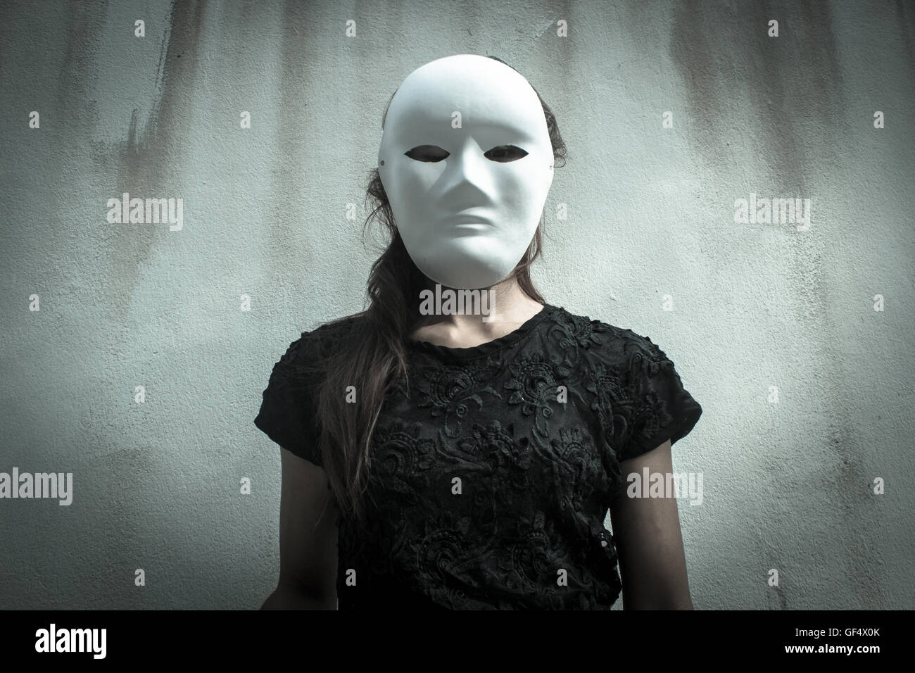 Mysterious woman in black dress wearing white mask,Scary background for ...