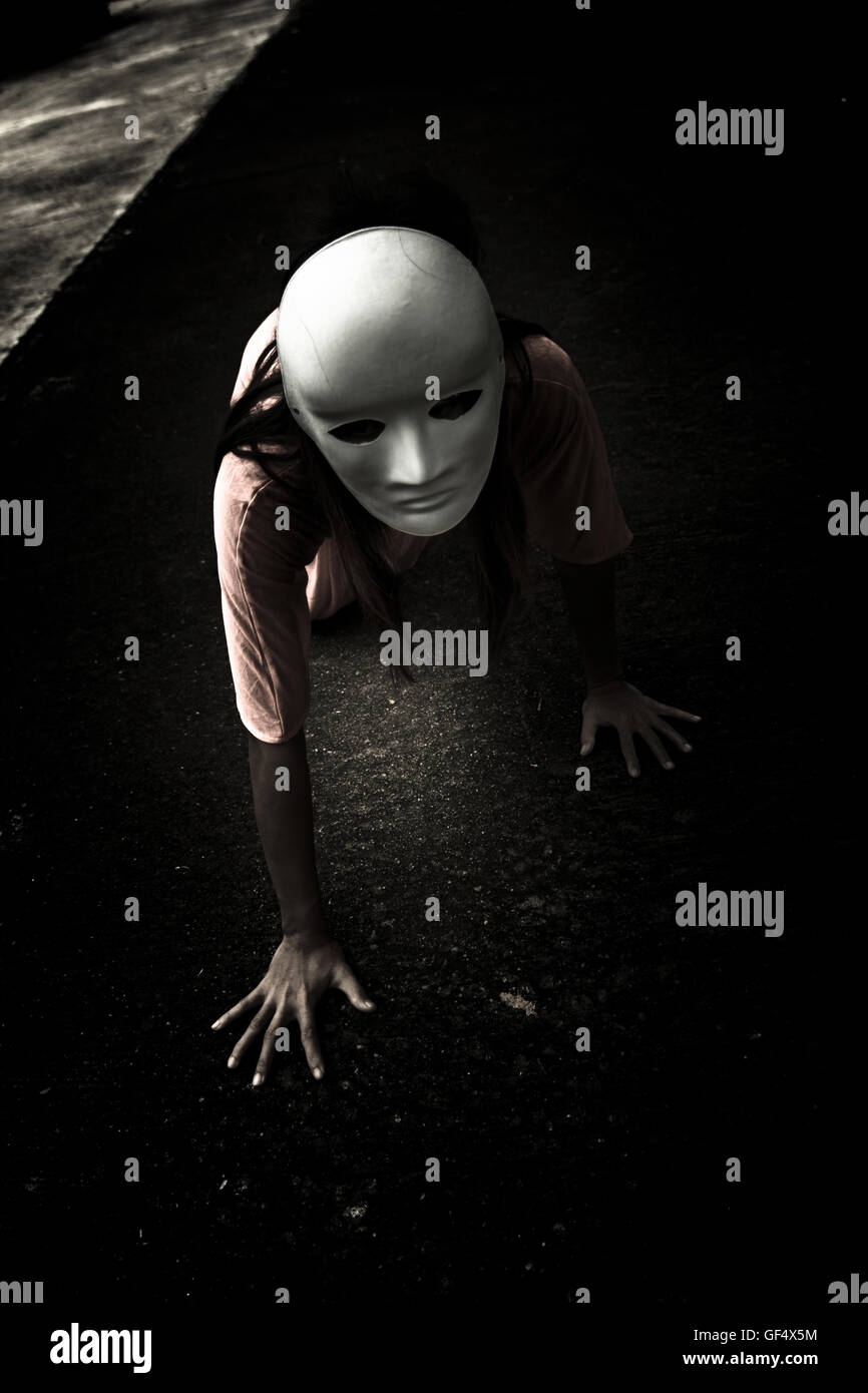 Mysterious woman in black dress wearing white mask,Scary background for ...