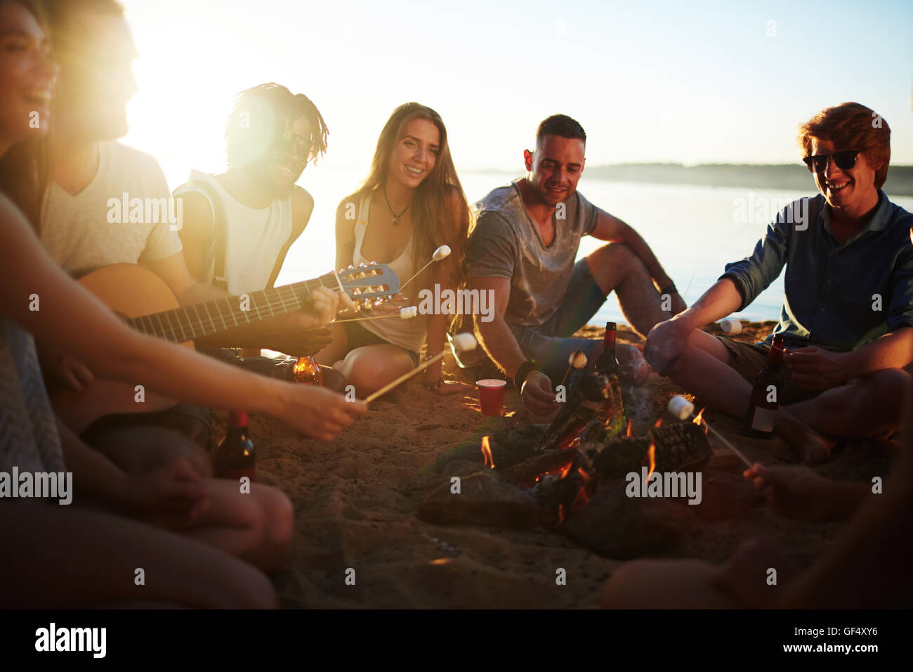 Friends by campfire Stock Photo - Alamy